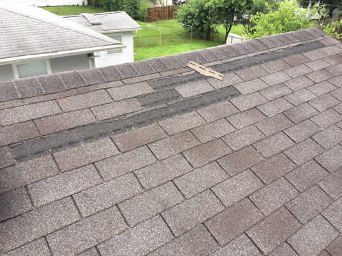 roof-creased-shingles-wind-damage | Gutter Guards Direct
